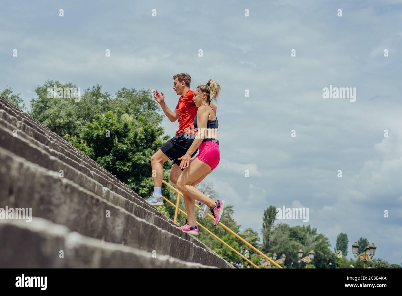 Healthy active couple exercising cardio and sprinting staircase in a ...