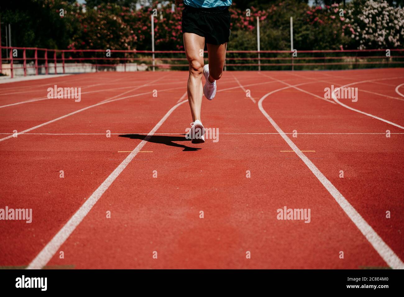 Legs of a man running on tartan track Stock Photo - Alamy