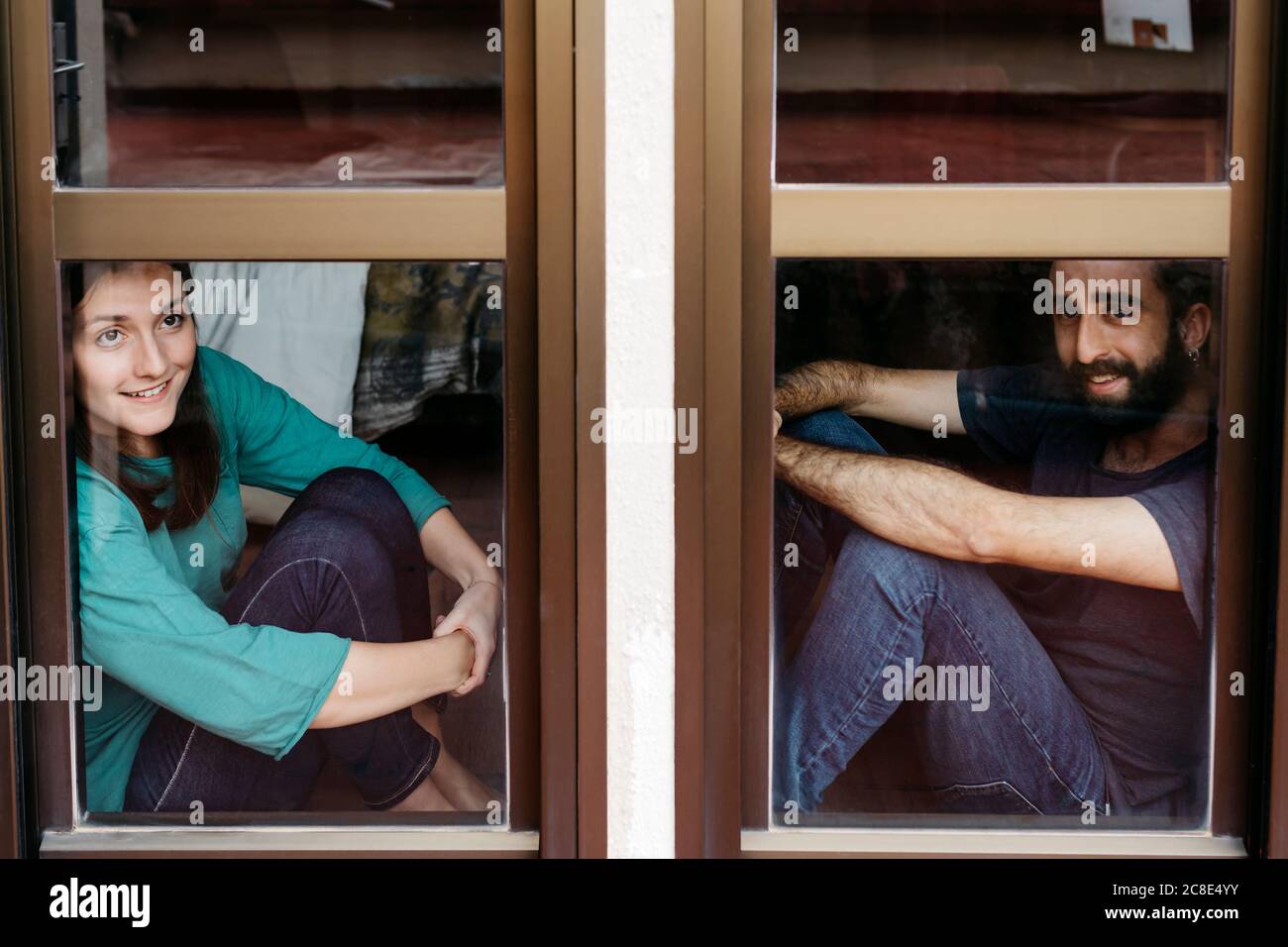 Couple looking out the window and thinking about the future Stock Photo ...