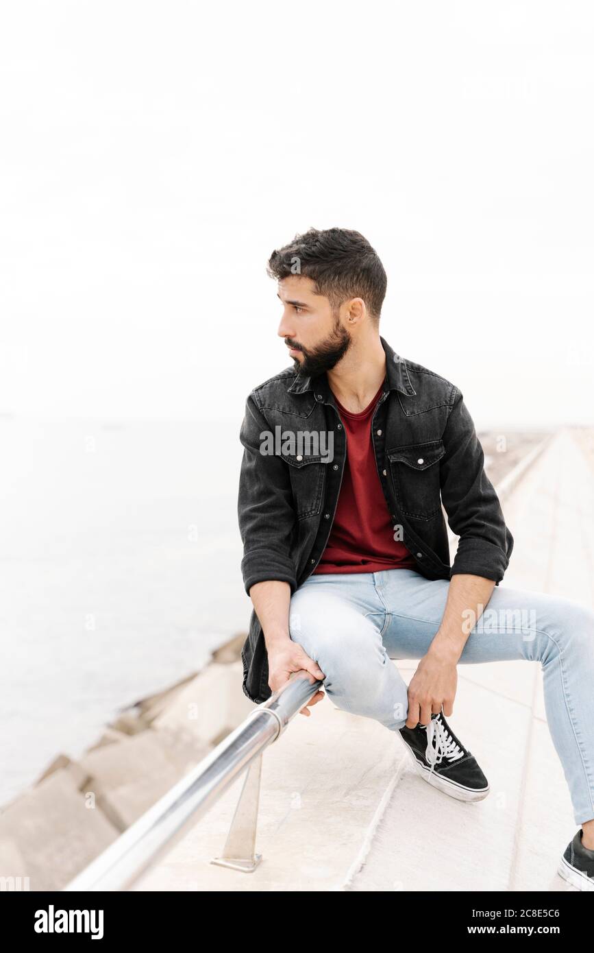 Man sitting on railing hi-res stock photography and images - Alamy