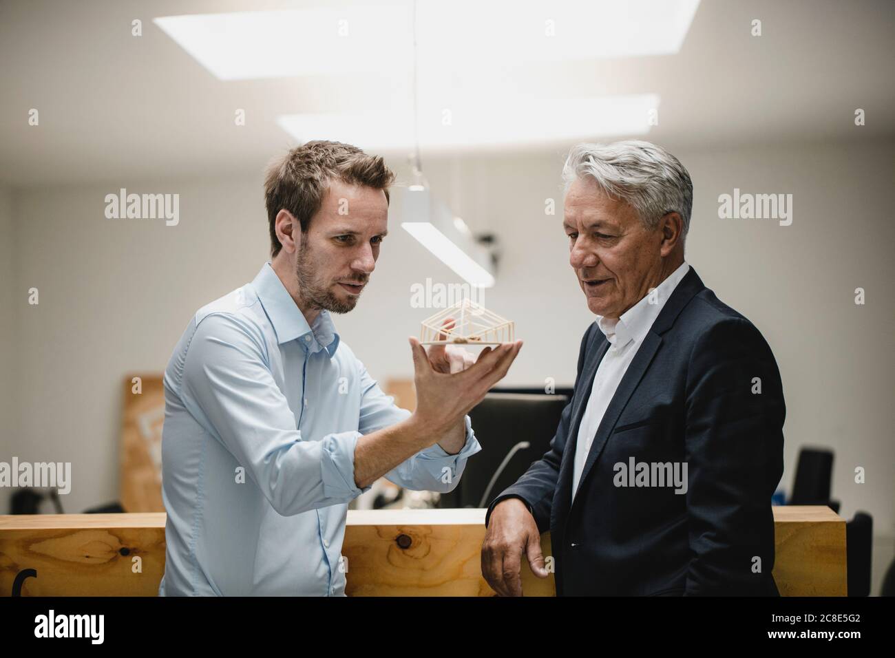 Architect presenting architectural modell to client Stock Photo - Alamy