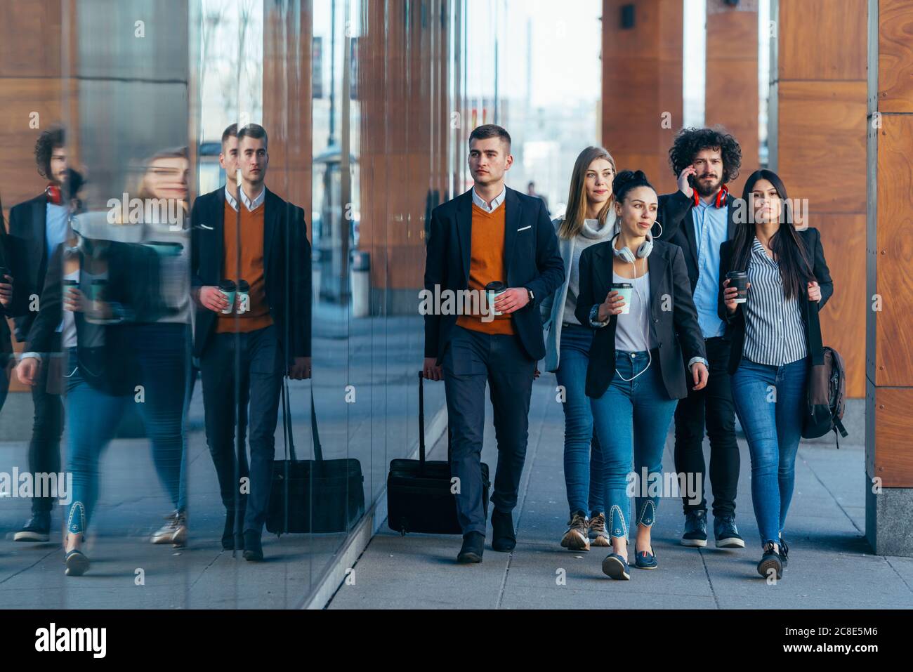 Group of colleagues on a business trip (euro trip) walking together at ...