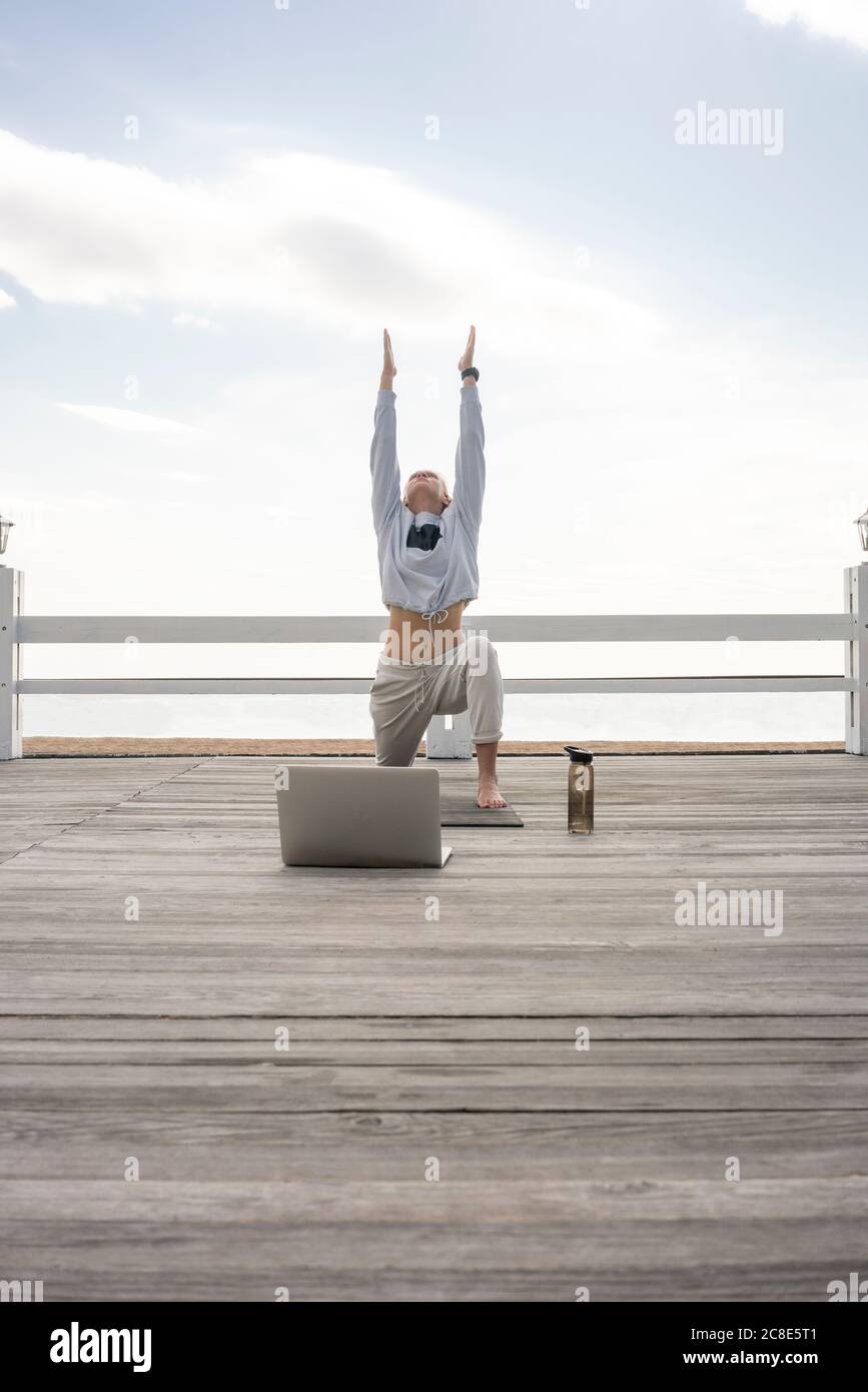 Woman using laptop stretching hi-res stock photography and images - Alamy
