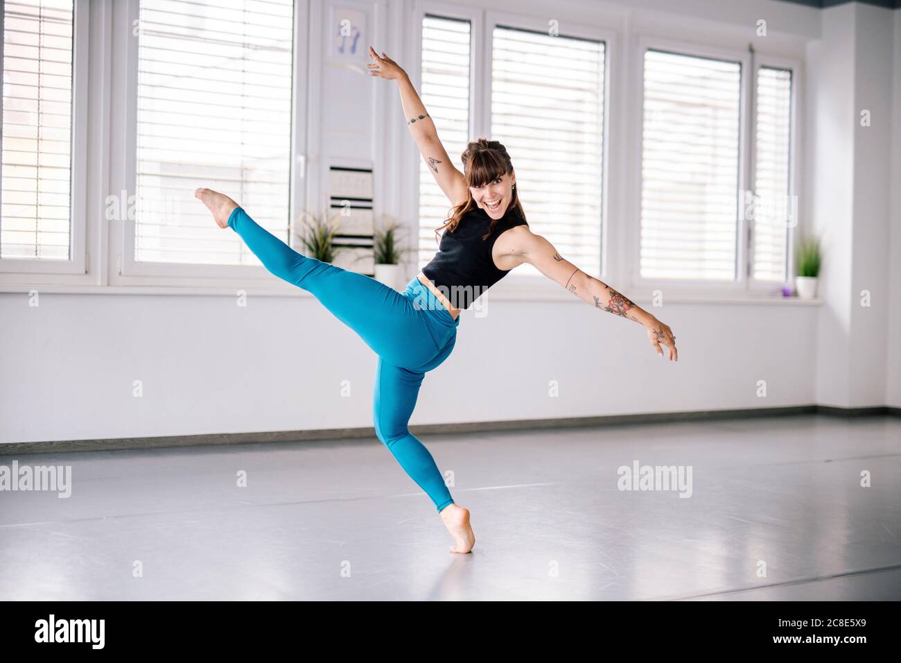 Cheerful female ballerina dancing in ballet studio Stock Photo - Alamy