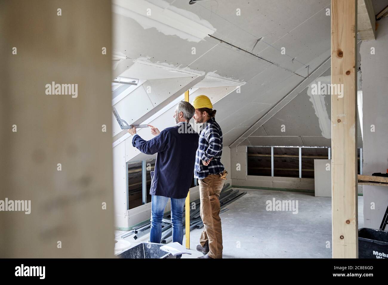 Architect and worker measuring window on a construction site Stock ...
