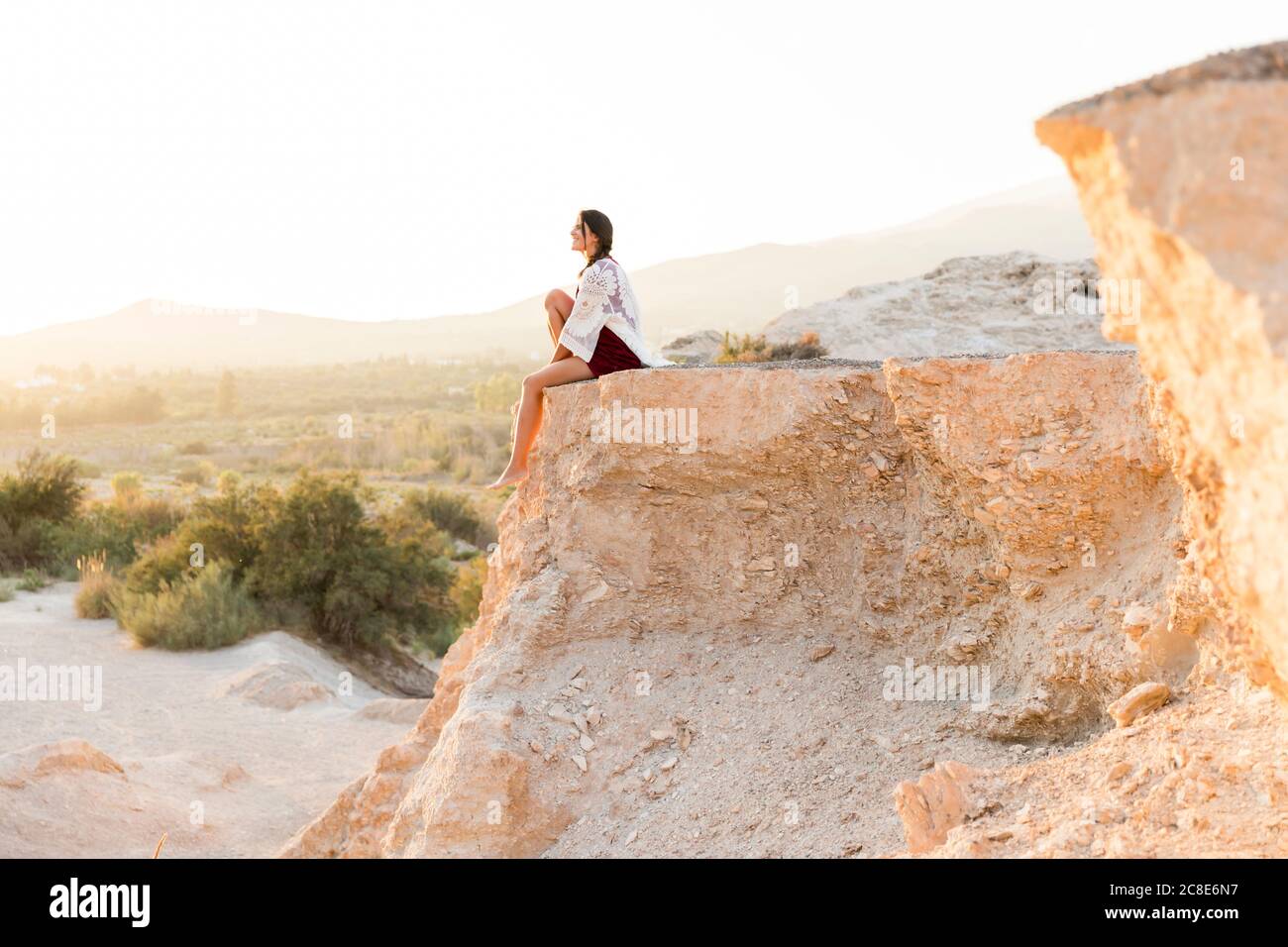 Person sitting on cliff hi-res stock photography and images - Alamy