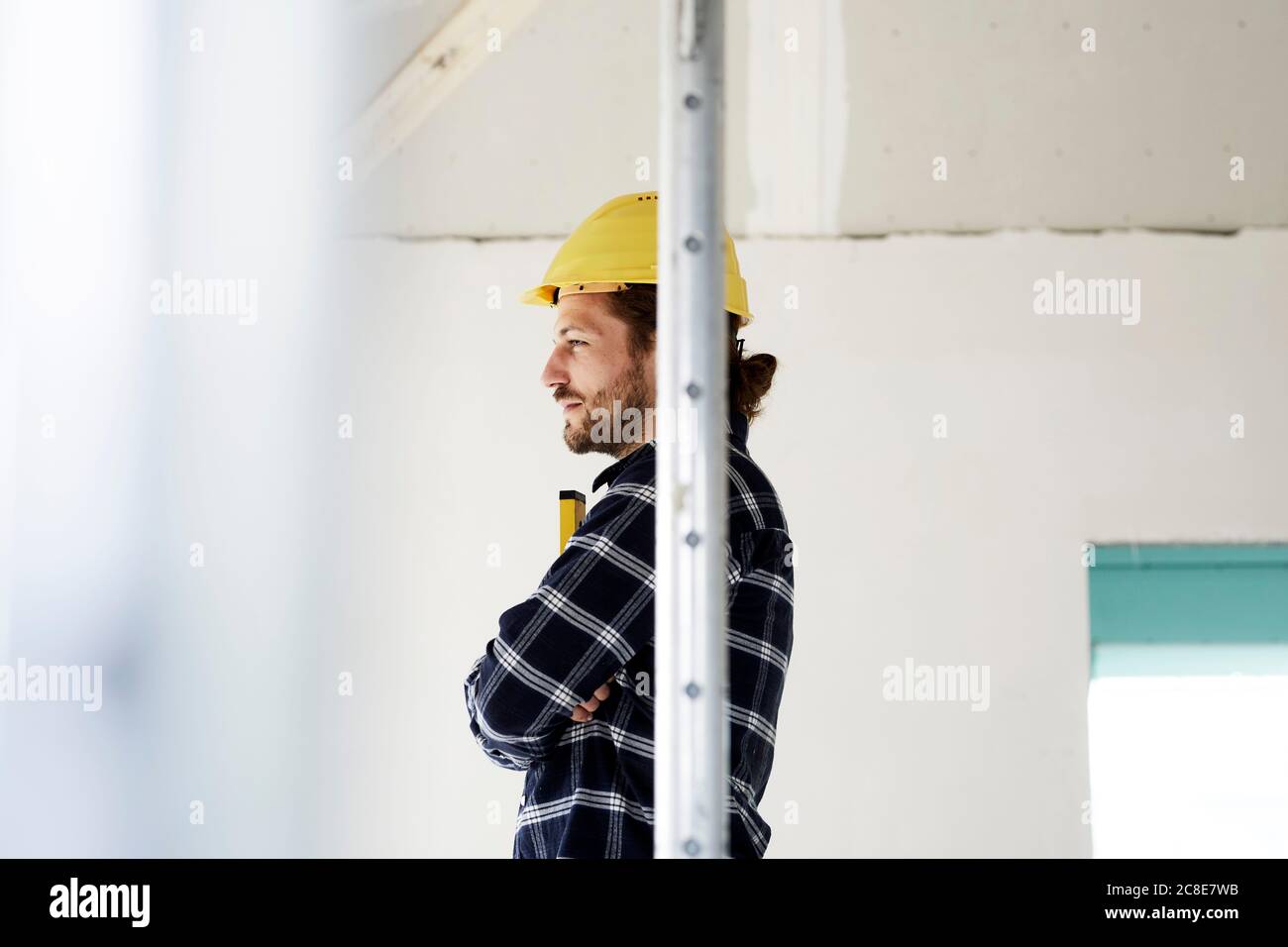 Pensive worker on a construction site Stock Photo - Alamy