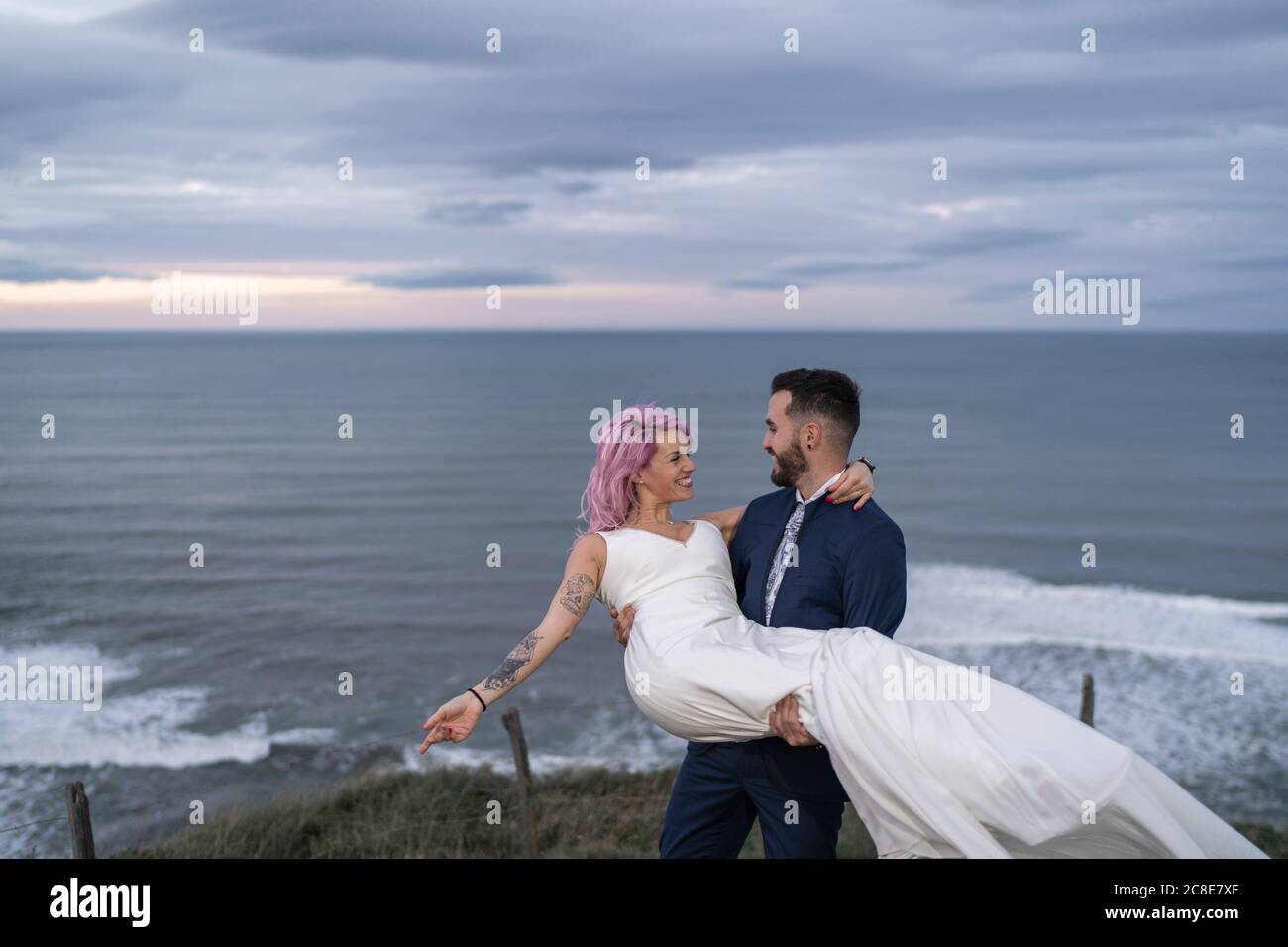 Bridal couple on viewpoint and ocean in the background Stock Photo - Alamy