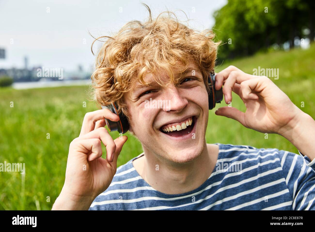 Man headphones laughing hi-res stock photography and images - Alamy