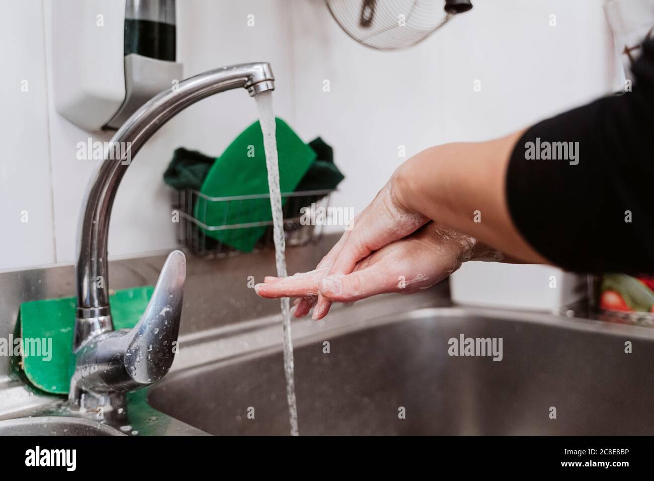 Female baker washing hands at bakery Stock Photo - Alamy