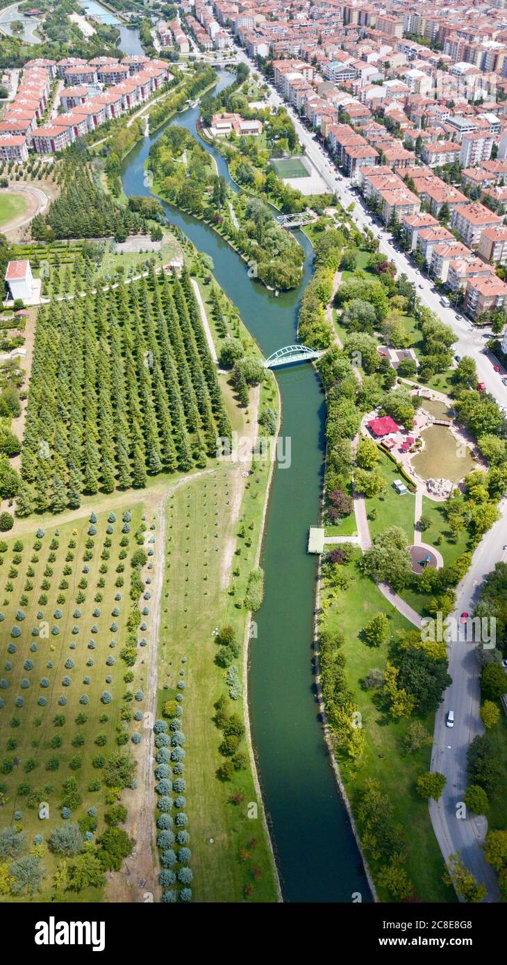 Aerial view of city. River, bridge, trees and building can be seen ...