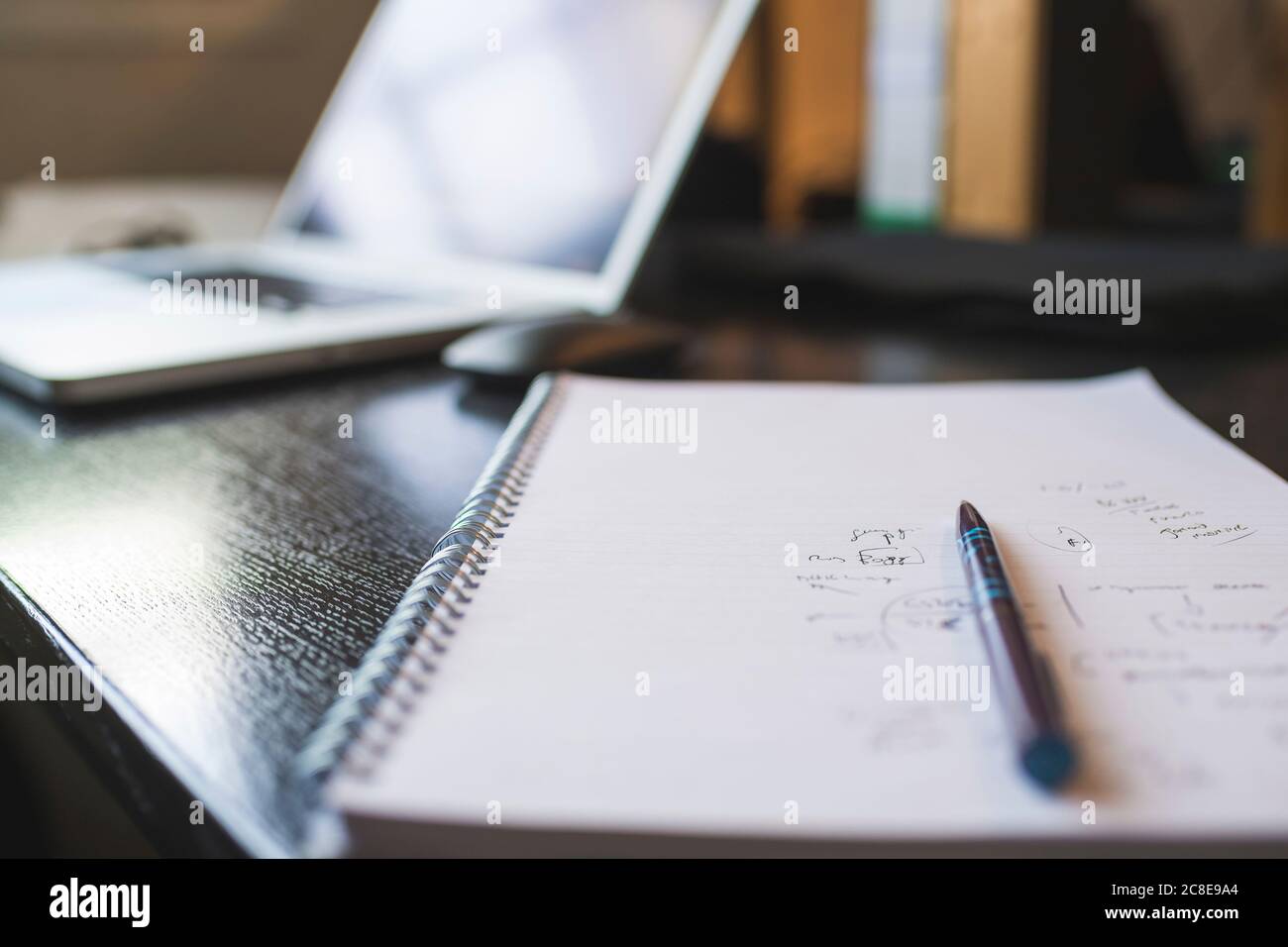 Laptop and notepad with pencil on desk in office Stock Photo - Alamy