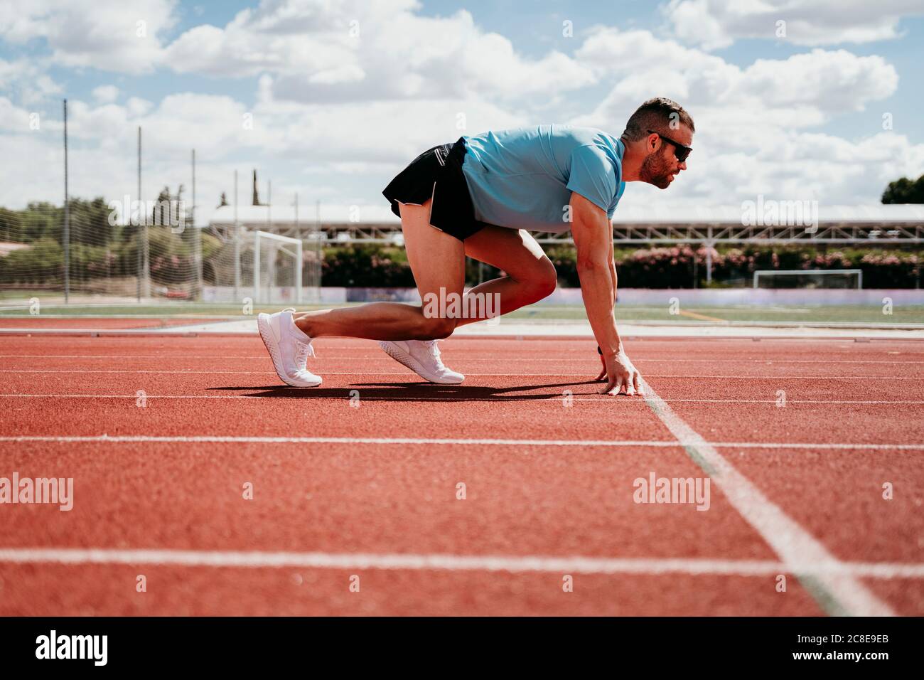 Man at running track in starting position hi-res stock photography and ...