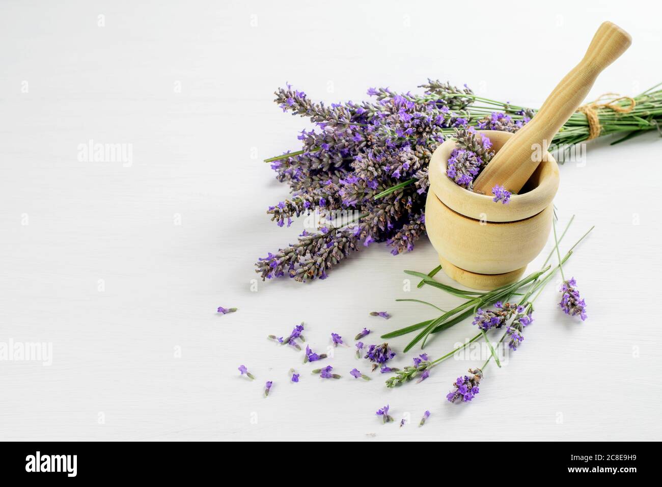 Lavender flowers on the white background and in the wooden mortar Stock Photo - Alamy