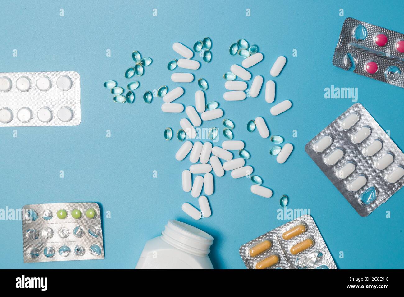 Pharmaceutical tablets, capsules and capsules on a blue background ...