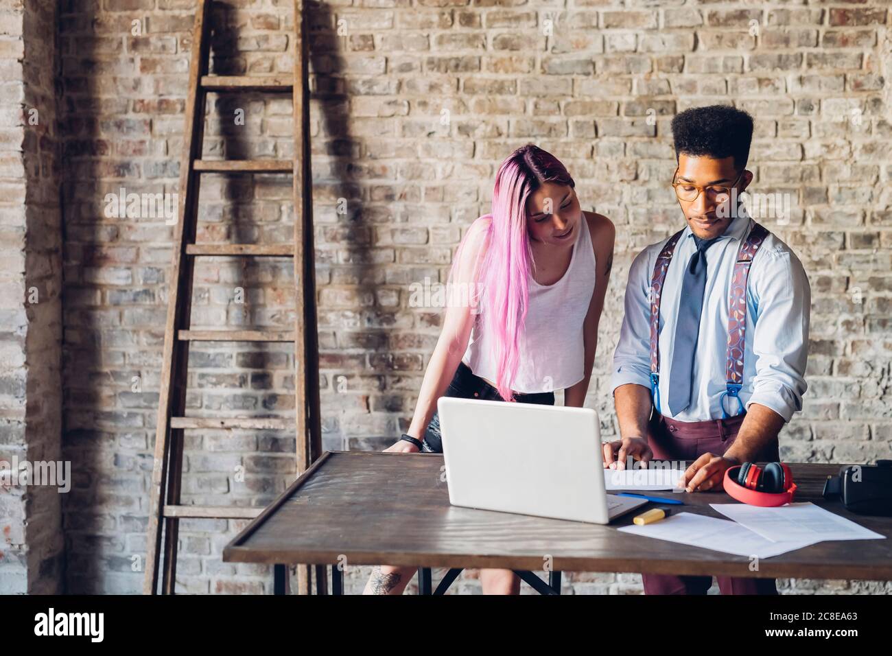 Two creative business people having a meeting in loft office Stock ...