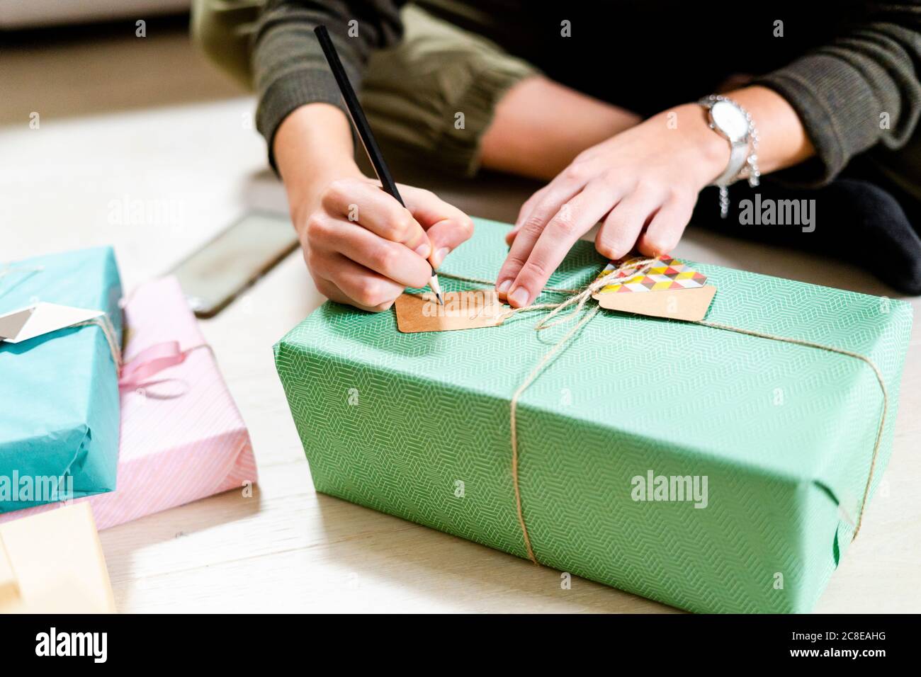 Close up of womans hands writing on paper Stock Photo - Alamy