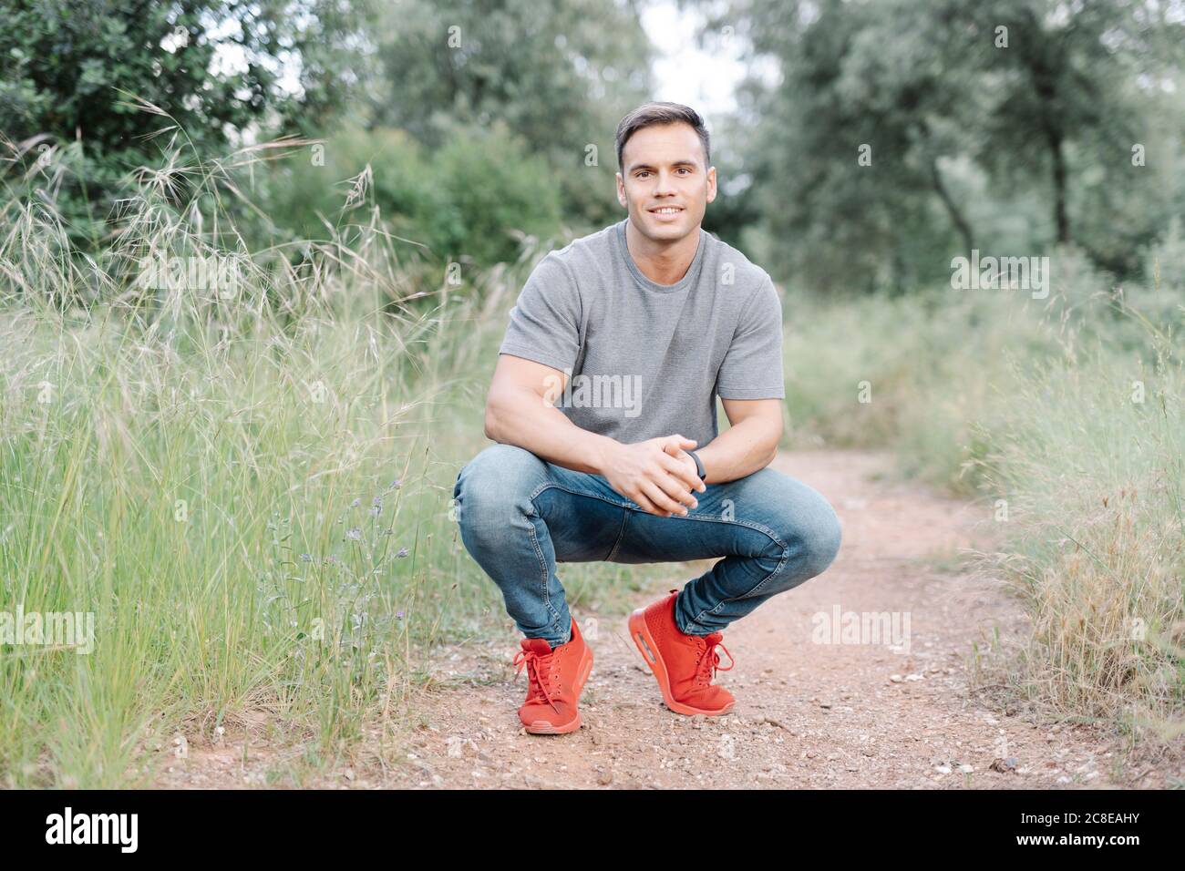 Crouching looking at camera hi-res stock photography and images - Alamy