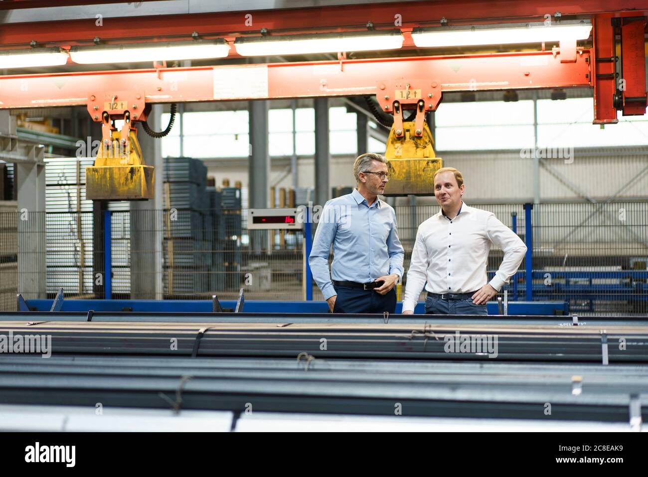 Two businessmen having a meeting in a factory Stock Photo - Alamy