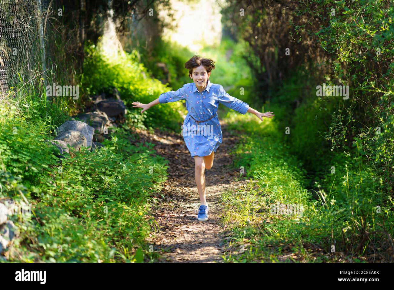 Girl running on a rural path Stock Photo - Alamy