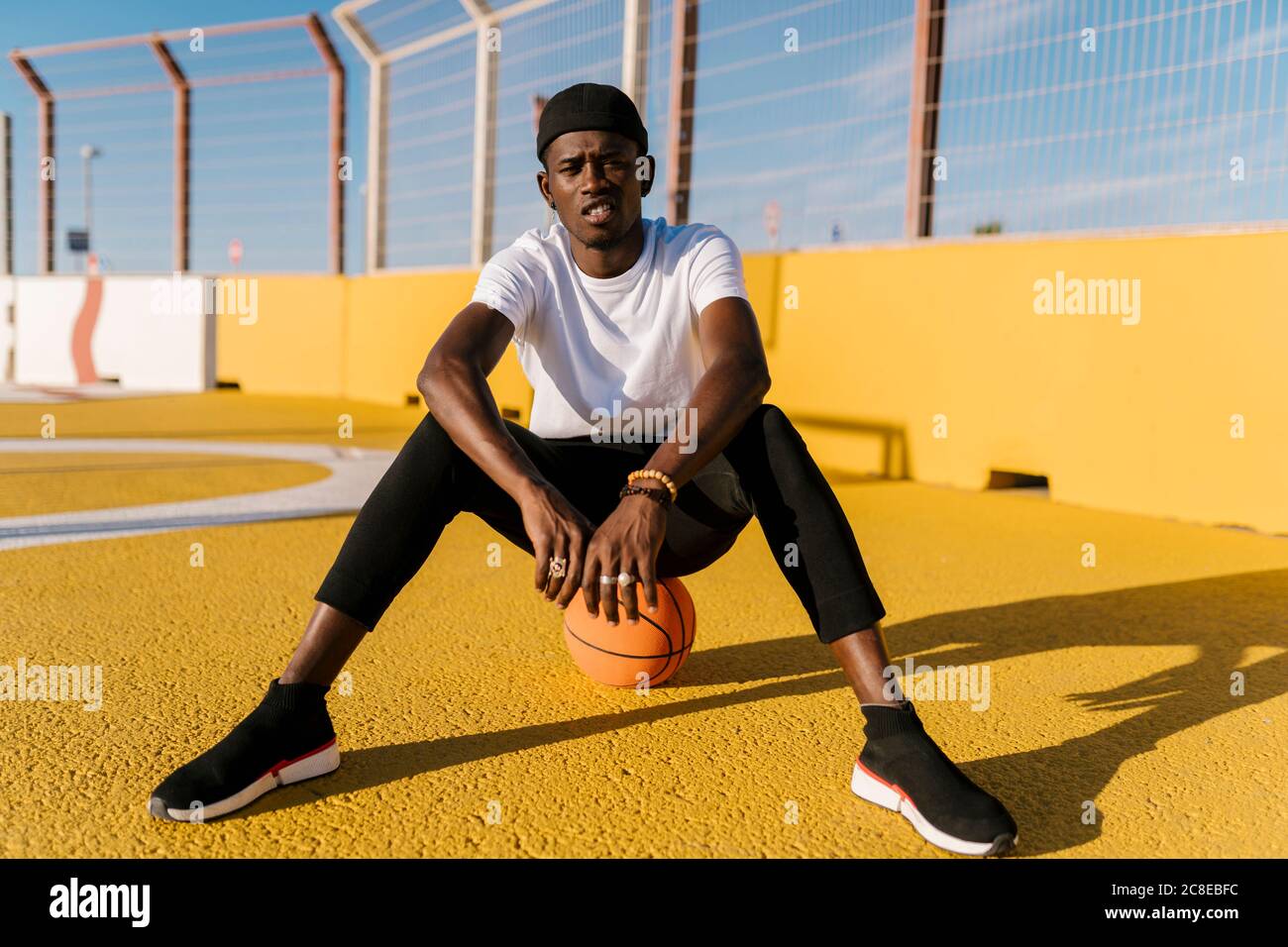 Portrait man sitting on basketball hi-res stock photography and images ...