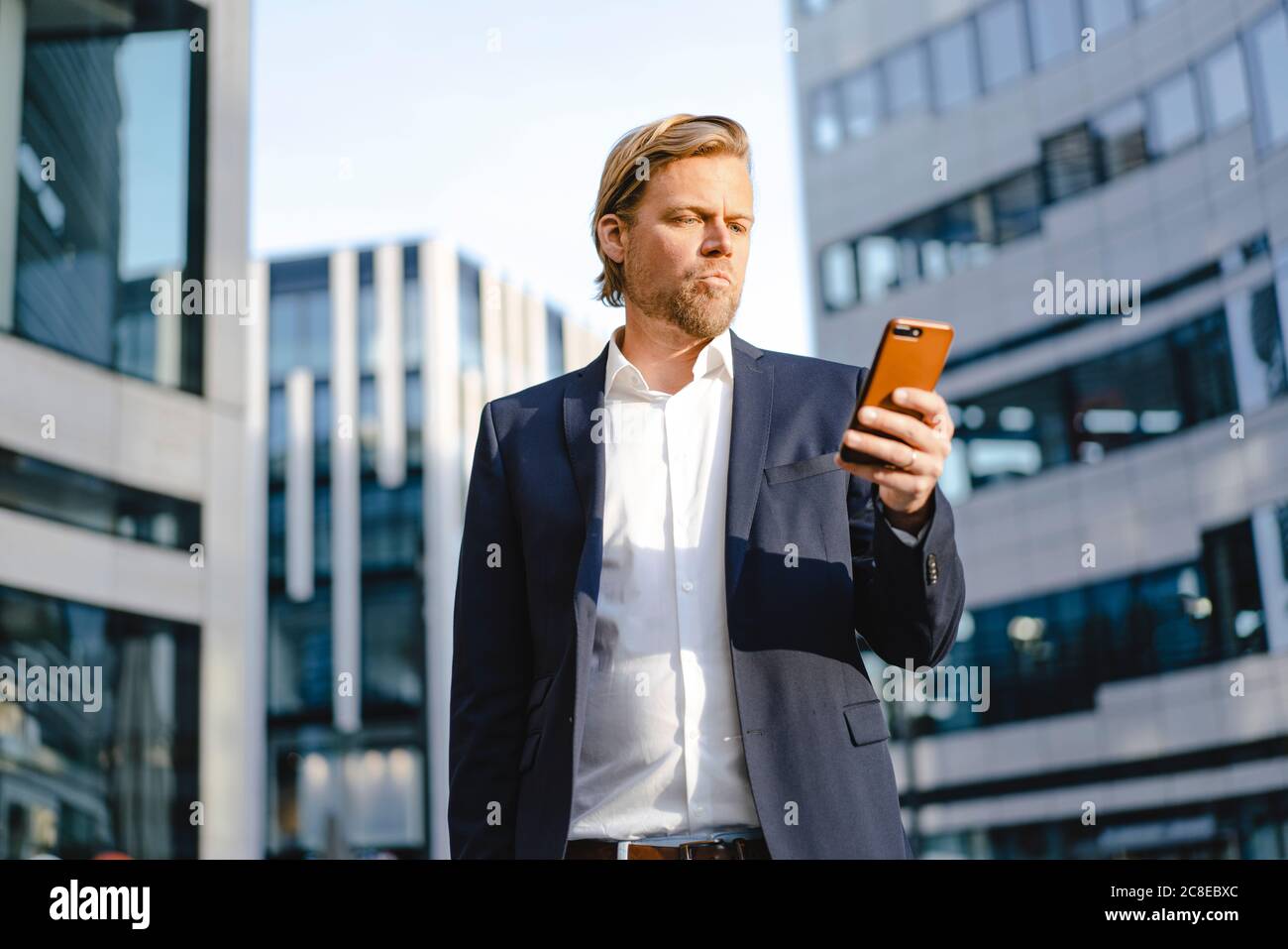 Serious businessman using smartphone hi-res stock photography and ...