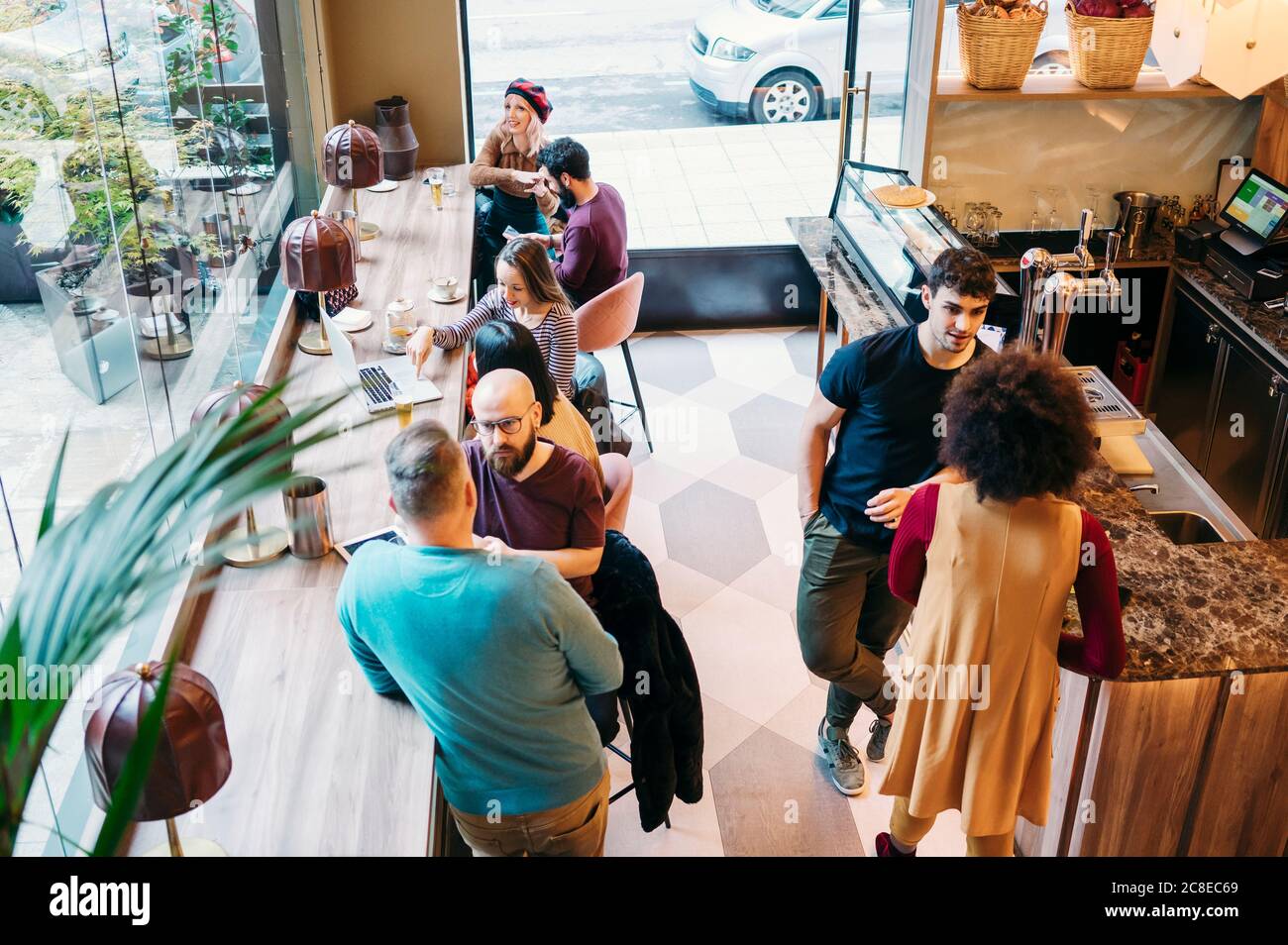 Friends meeting in fancy restaurant, talking at the bar Stock Photo - Alamy