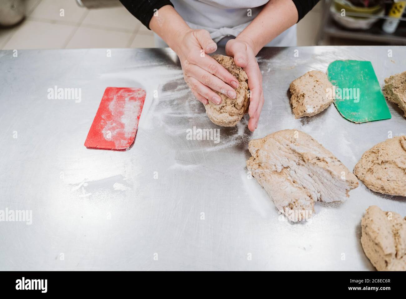 Female baker preparing bread loaf on kitchen counter in bakery Stock ...
