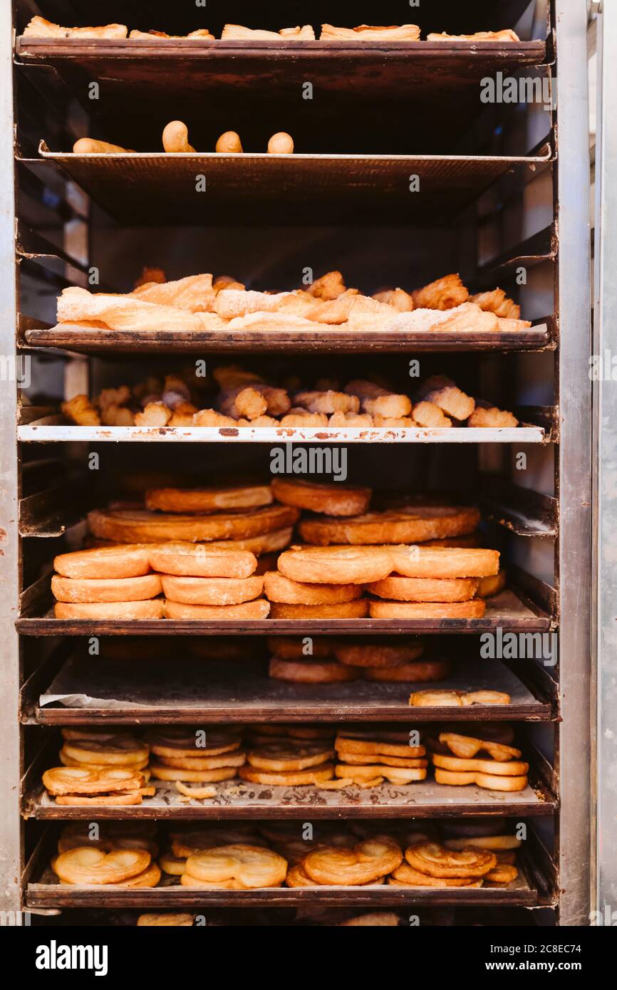 Various bread and cookies in shelves of trolley at bakery Stock Photo ...