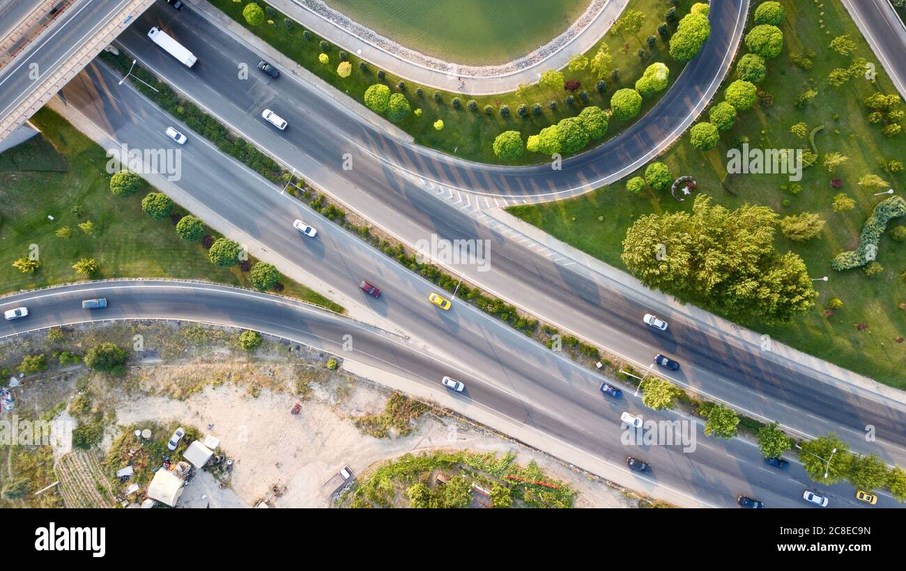 Aerial view of the roundabout on the river. Trees, overpass, buildings ...