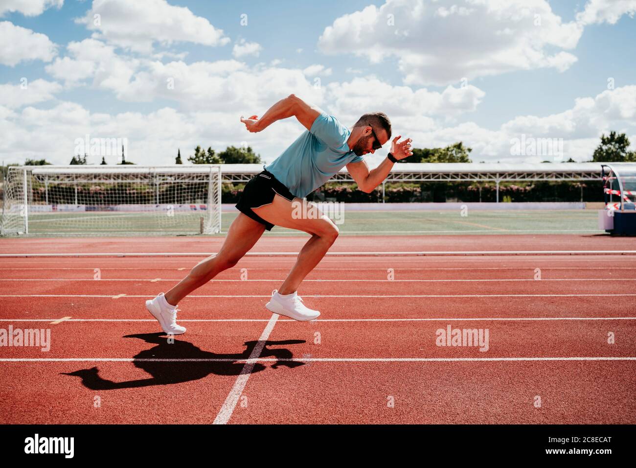 Man running on tartan track Stock Photo - Alamy