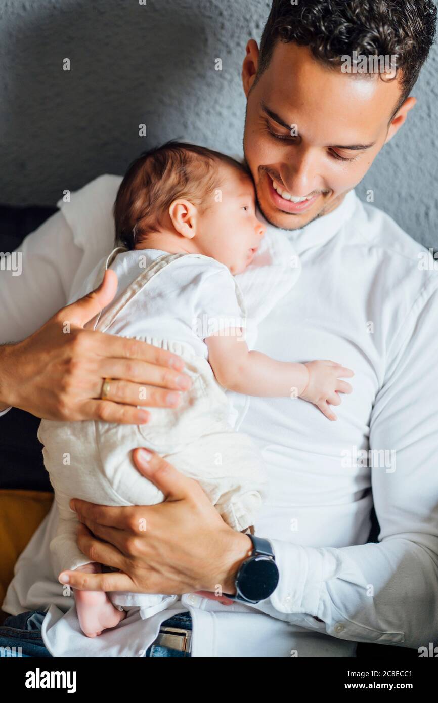 Happy father carrying baby boy at home Stock Photo - Alamy