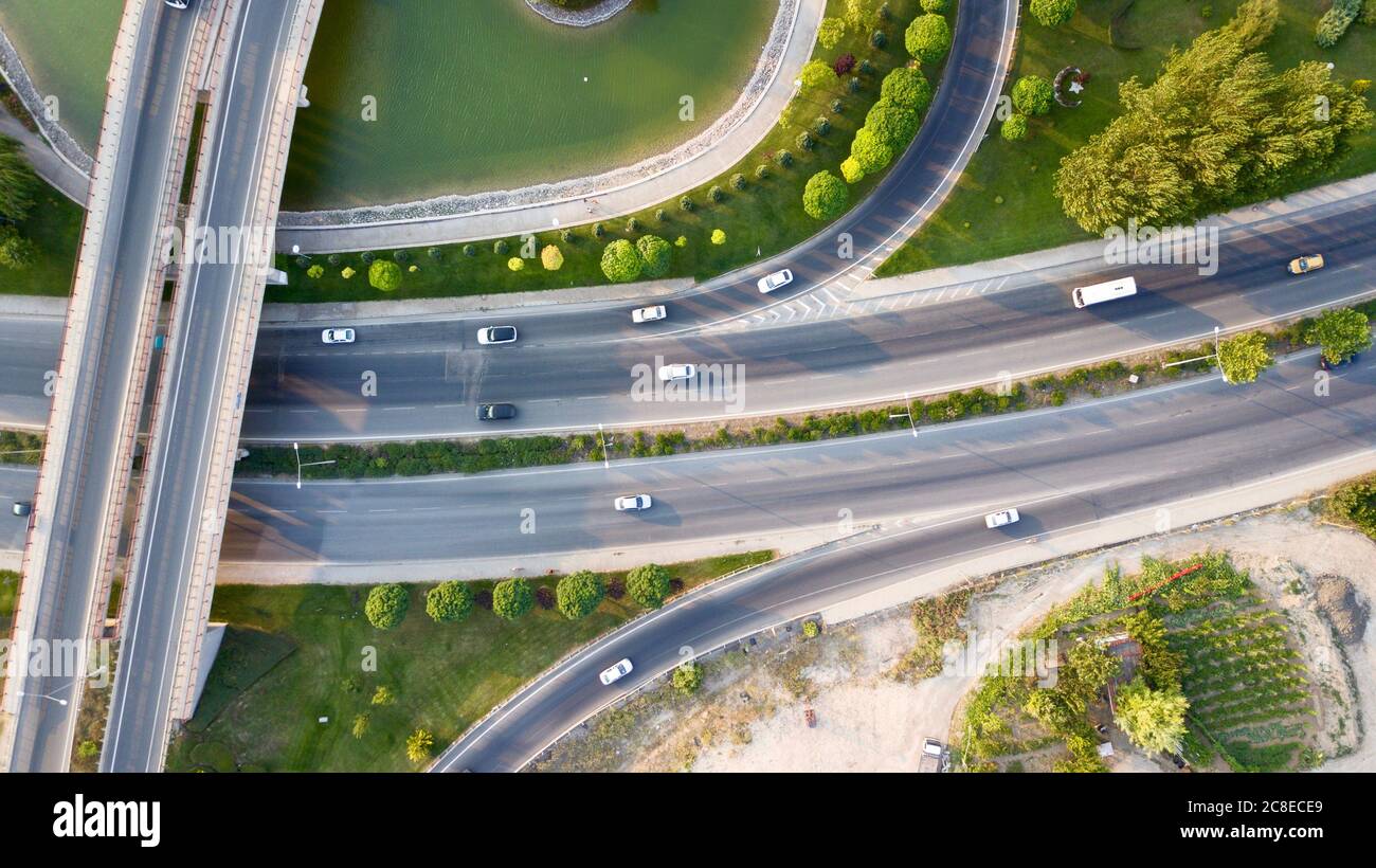 Aerial view of the roundabout on the river. Trees, overpass, buildings ...