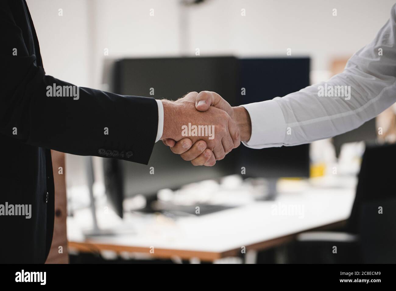 Handshake two businessmen office hi-res stock photography and images - Alamy