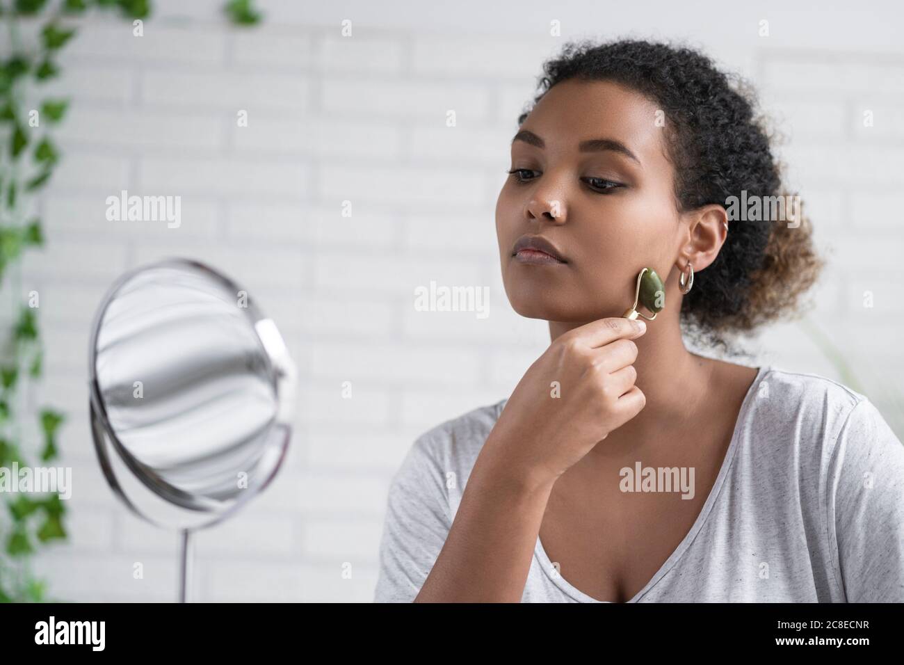 Woman looking in mirror at face hi-res stock photography and images - Alamy