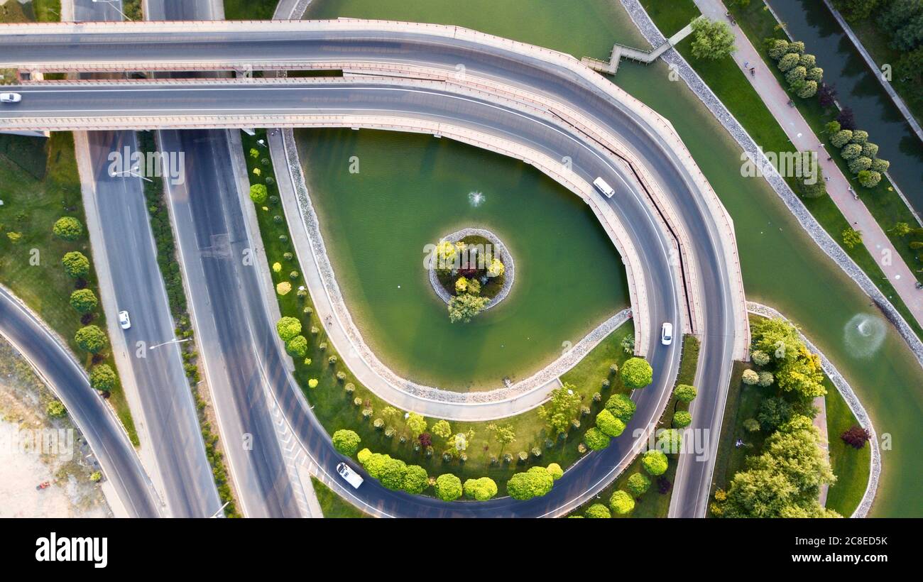 Aerial view of the roundabout on the river. Trees, overpass, buildings ...