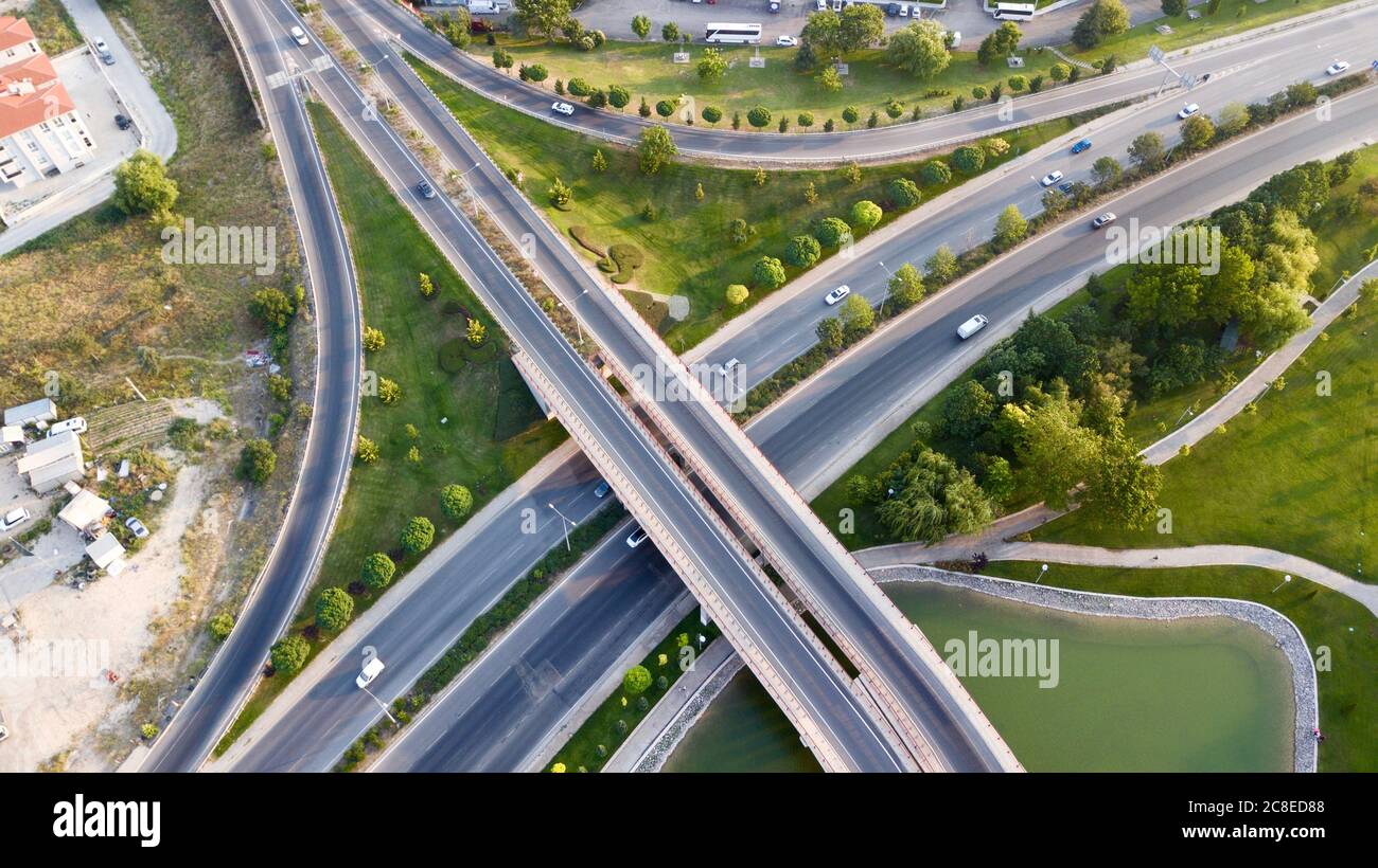Aerial view of the roundabout on the river. Trees, overpass, buildings ...