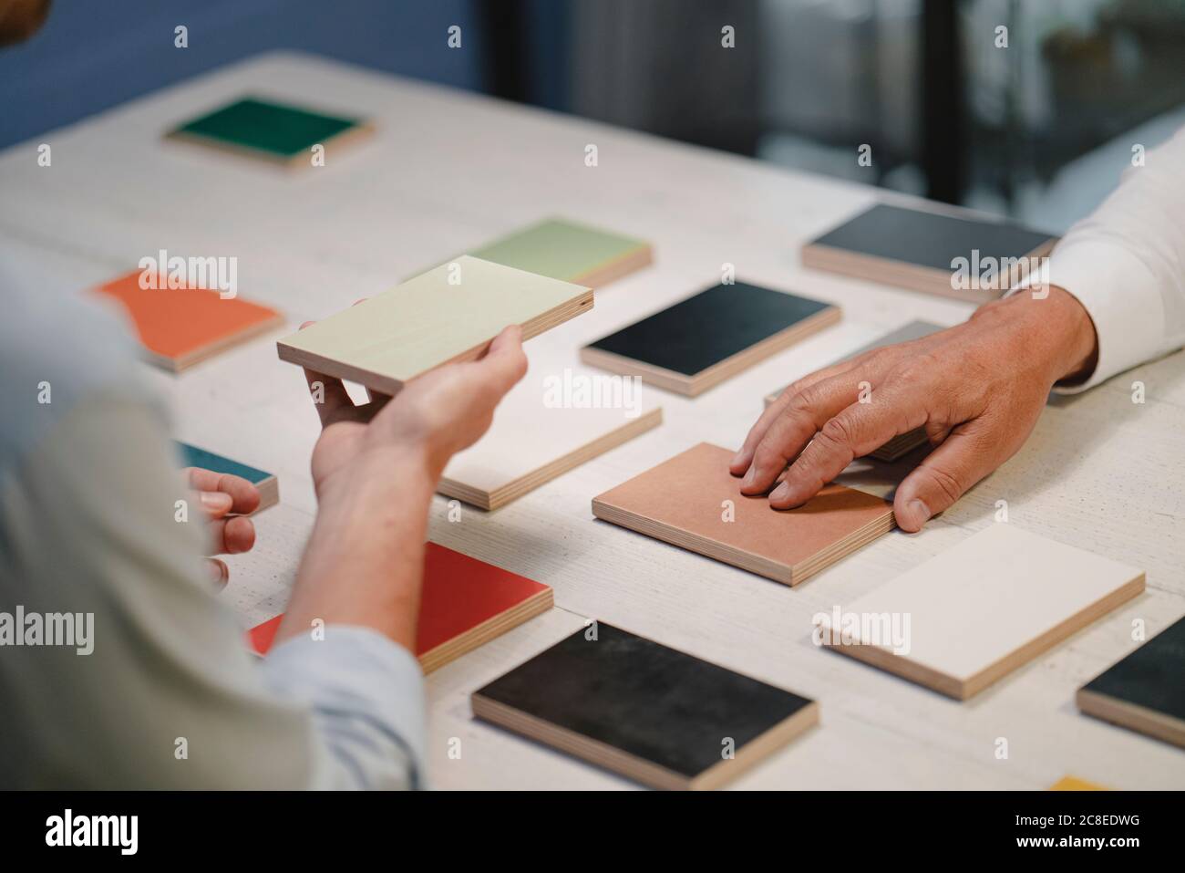 Hands of architects choosing colour samples in office Stock Photo - Alamy