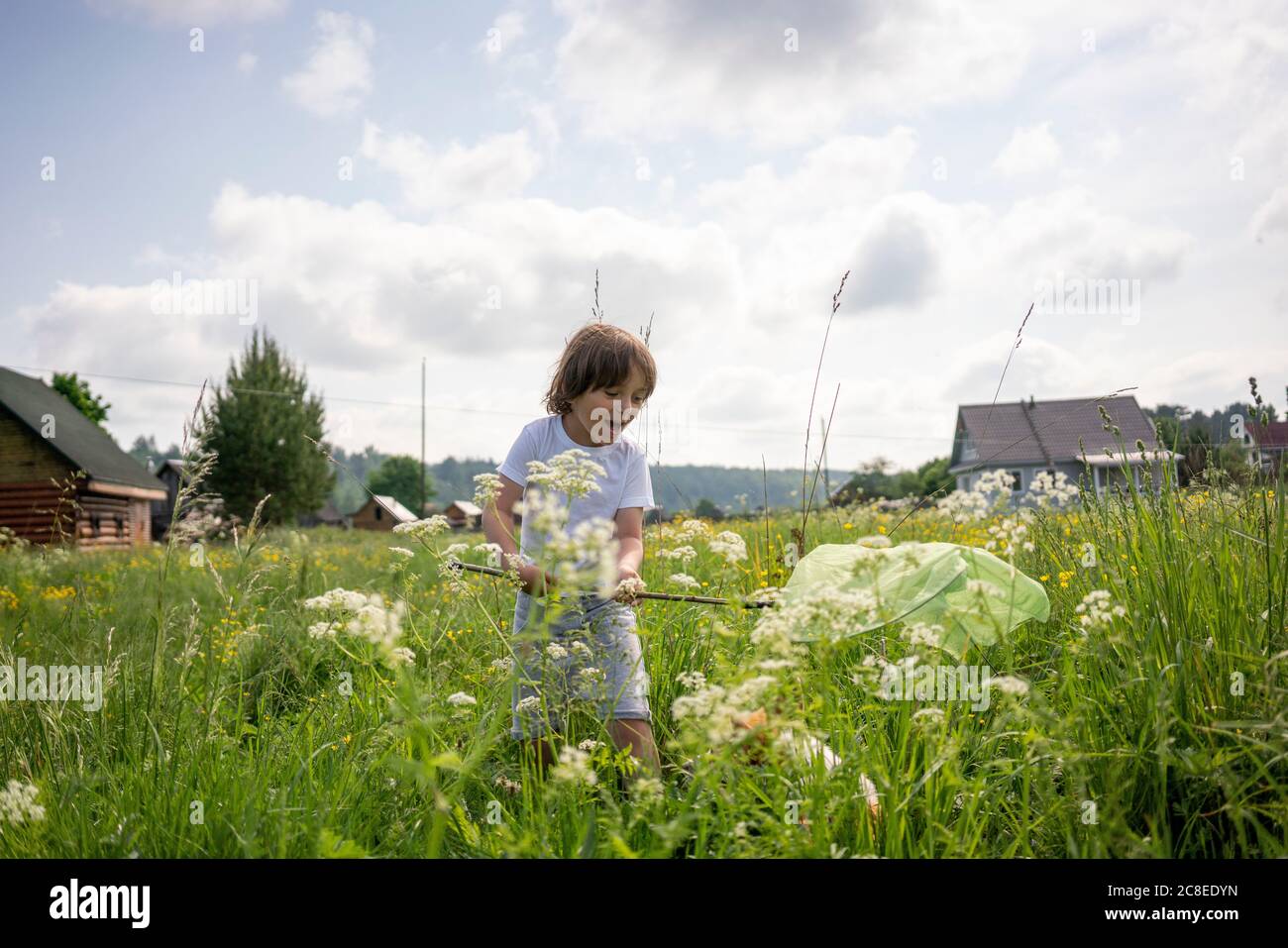 Boy catching butterfly hi-res stock photography and images - Alamy