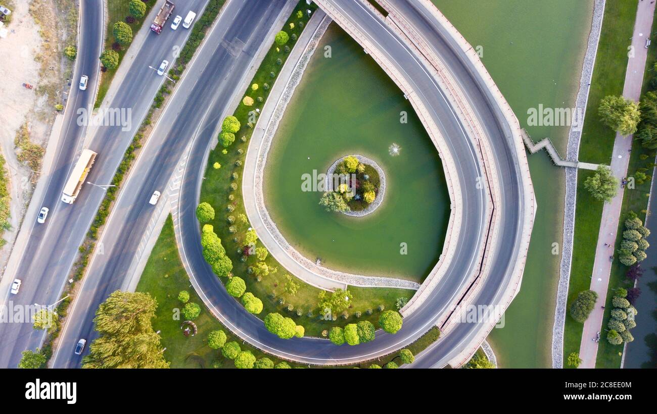Aerial view of the roundabout on the river. Trees, overpass, buildings ...