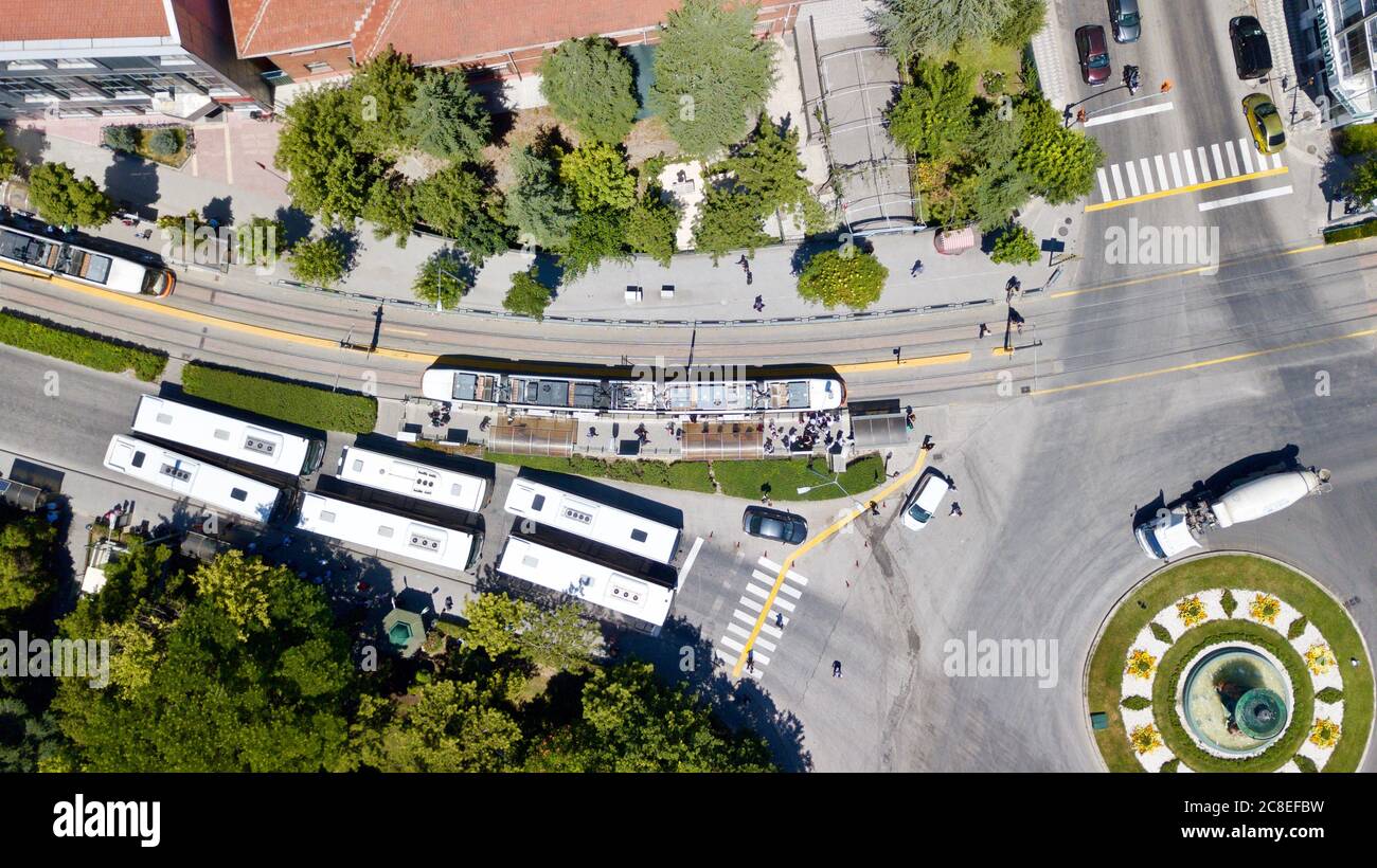 Aerial view of tram station at the city center. City buses are waiting ...