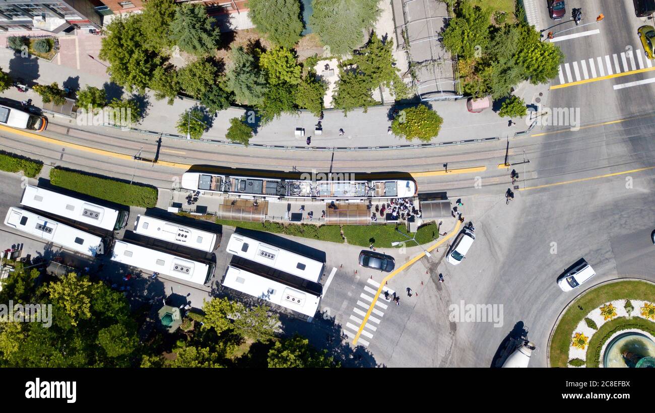 Aerial view of tram station at the city center. City buses are waiting ...