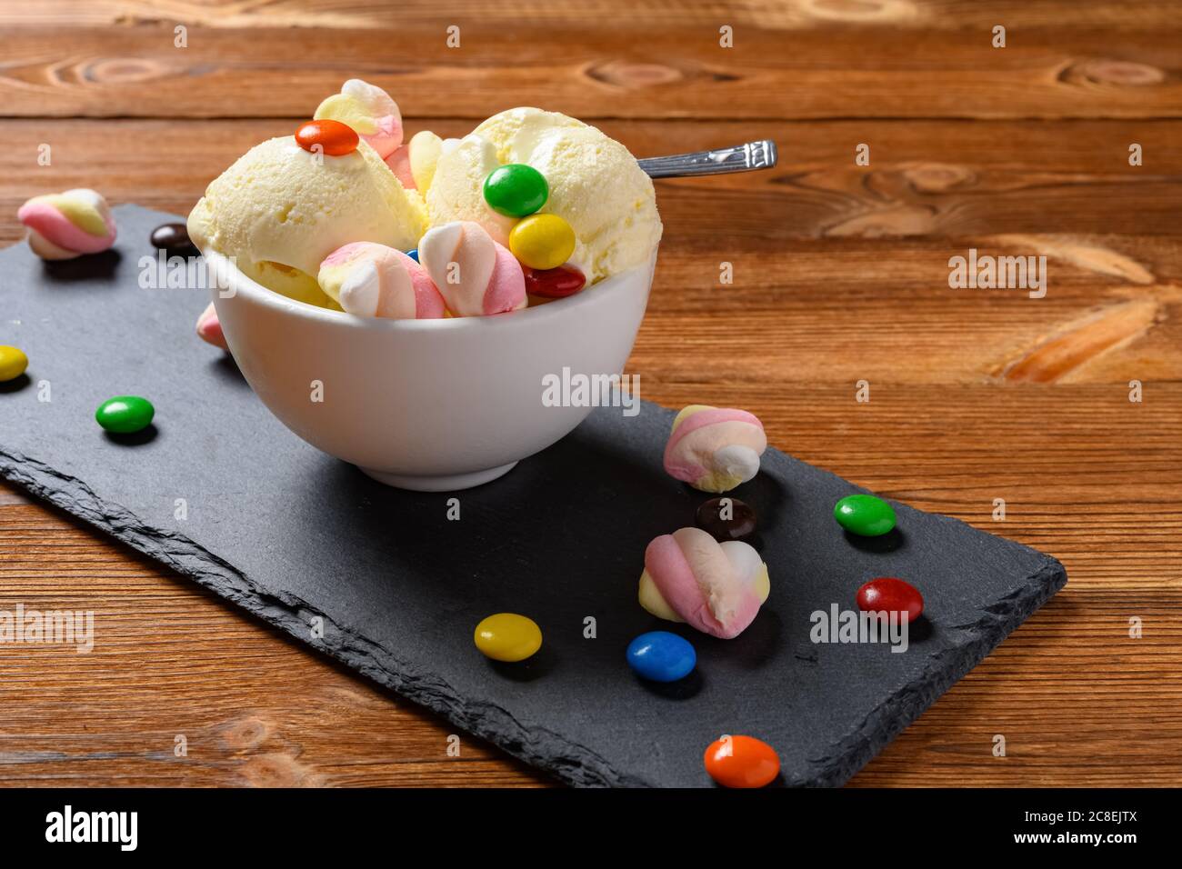 side view fresh vanilla flavor ice cream sundae with chocolate buttons ...