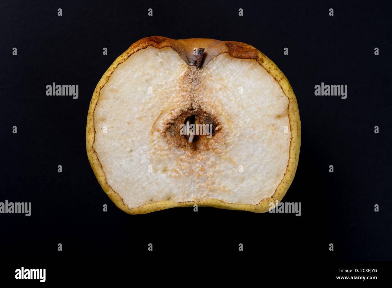 cut out section of an overripe pear on black background Stock Photo - Alamy