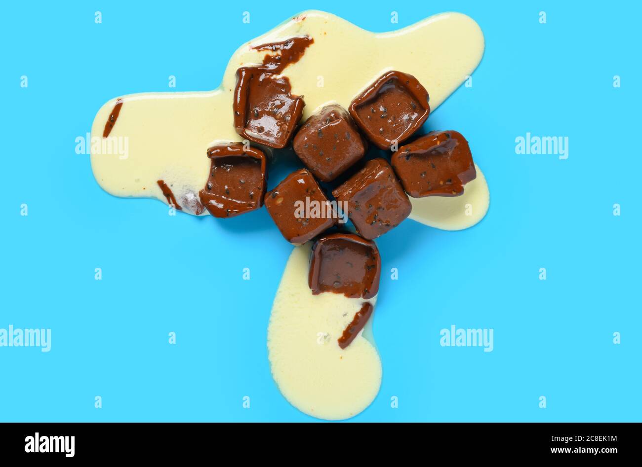 half melted chocolate blocks with vanilla flavor ice cream inside on ...