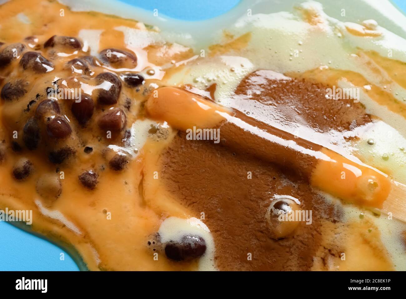 melted orange color chocolate outer popsicle with beans Stock Photo - Alamy