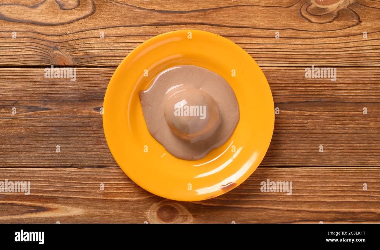 half melted chocolate ice cream ball on a dish Stock Photo - Alamy
