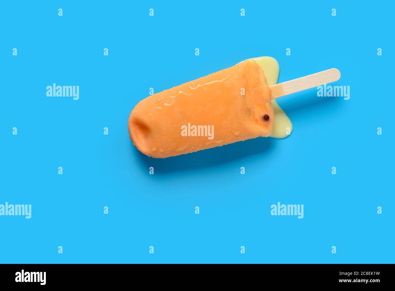 top view orange color chocolate outer popsicle with beans inside starts ...