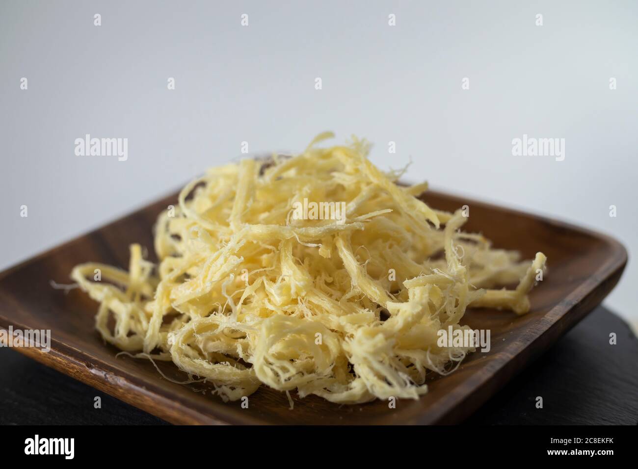 Japanese dried smoked squid in the wooden plate. Close-up view Stock ...