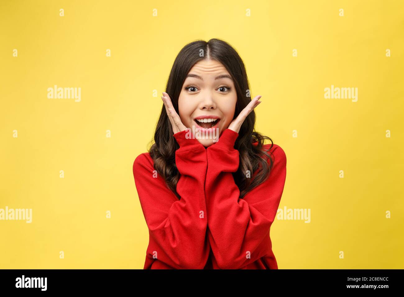 Portrait Happy Asian girl is surprised she is excited.Yellow background ...